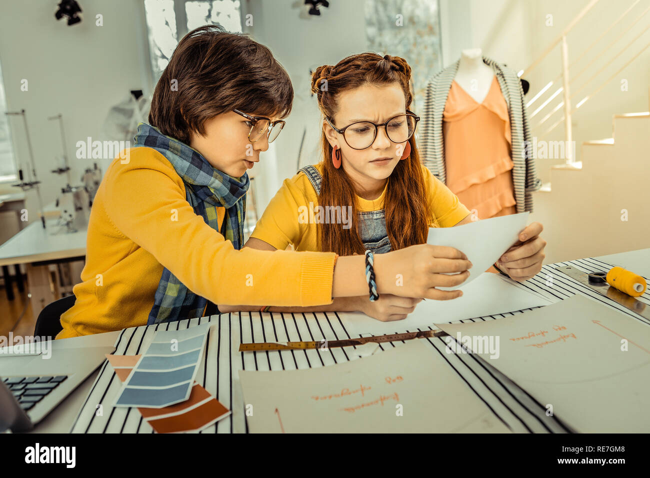 Cute stylish boy helping his classmate with difficult homework Stock ...