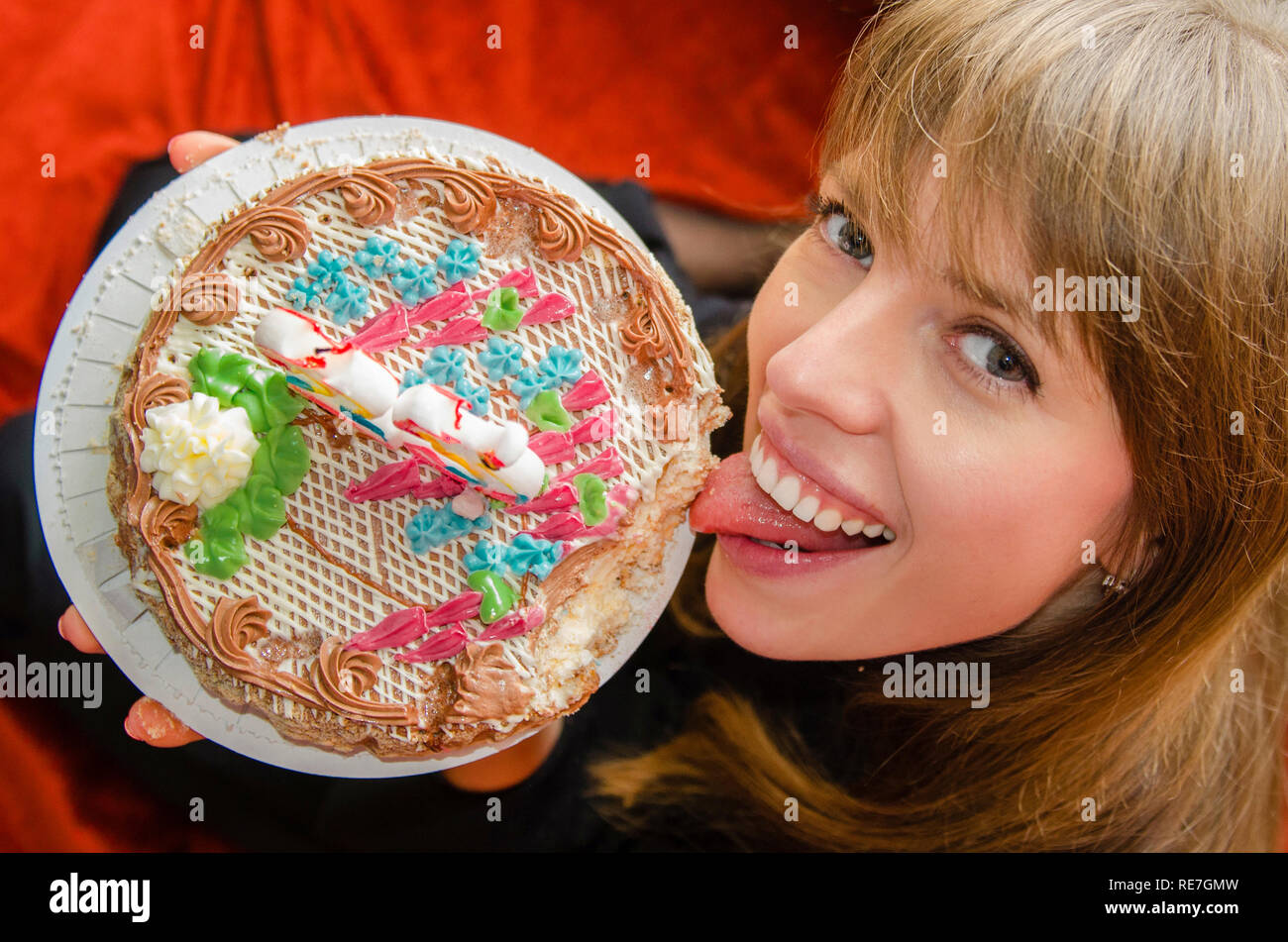 Happy girl smiling with a birthday cake in front of her face Stock ...