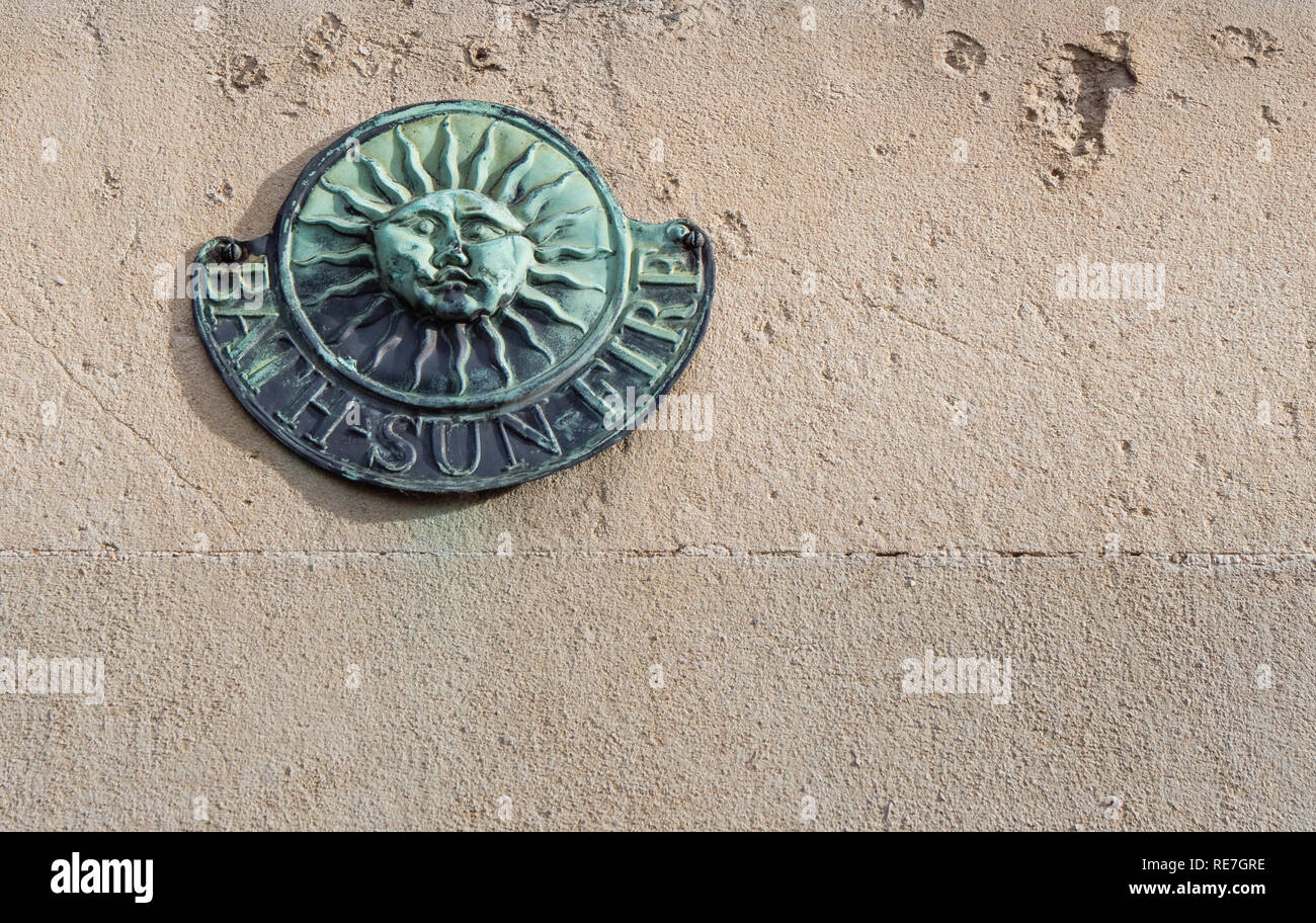 Bronze Bath Sun Fire insurance plaque on the wall of a Georgian stone ...