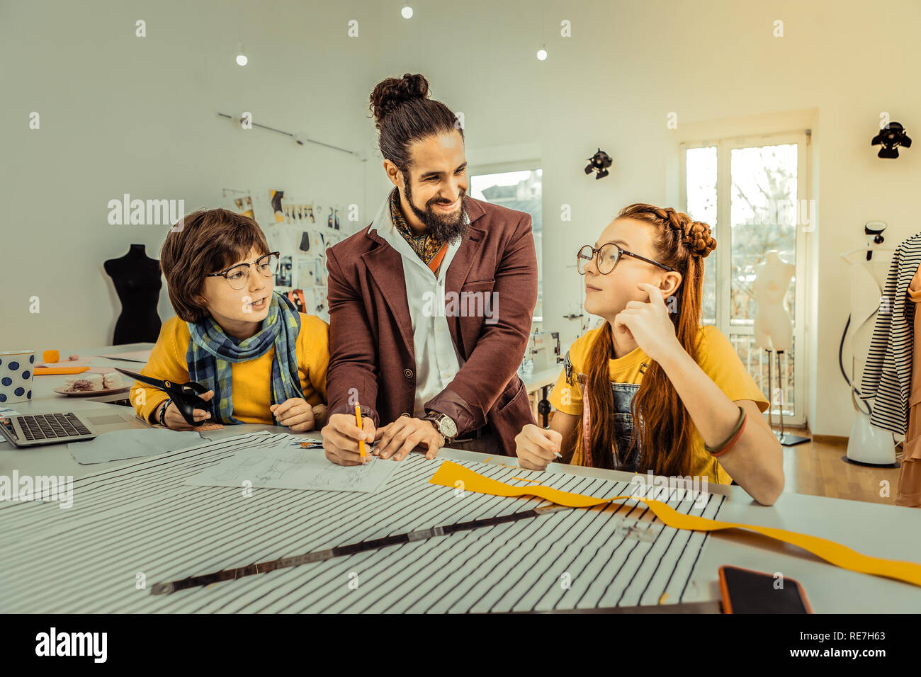 Father working as fashion designer teaching his children Stock Photo ...