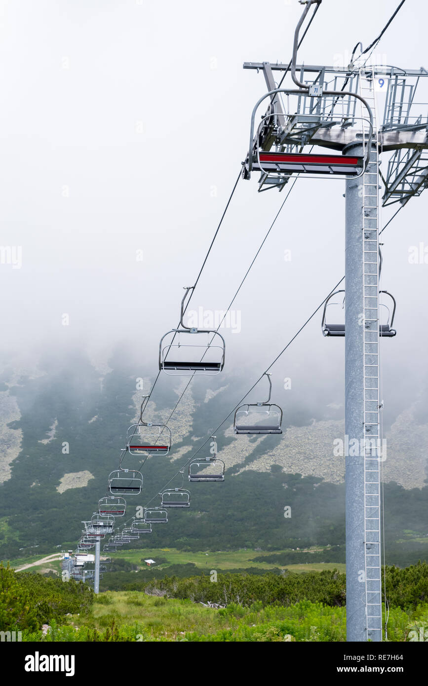 Mountain chairlift. An elevated passenger ropeway Stock Photo - Alamy