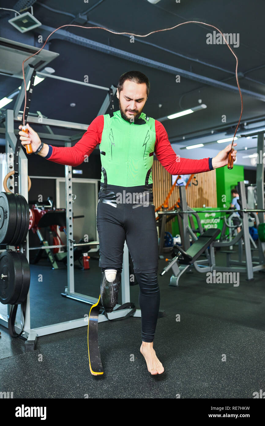 Muscular handsome young bearded man with fitness prosthetic leg wearing ...