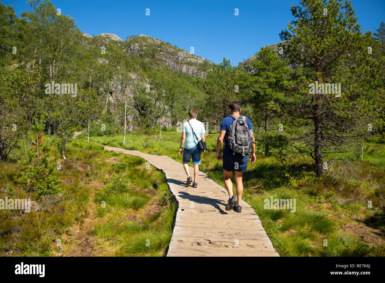 Hikers going to Preikestolen - famous cliff at the Norwegian mountains ...