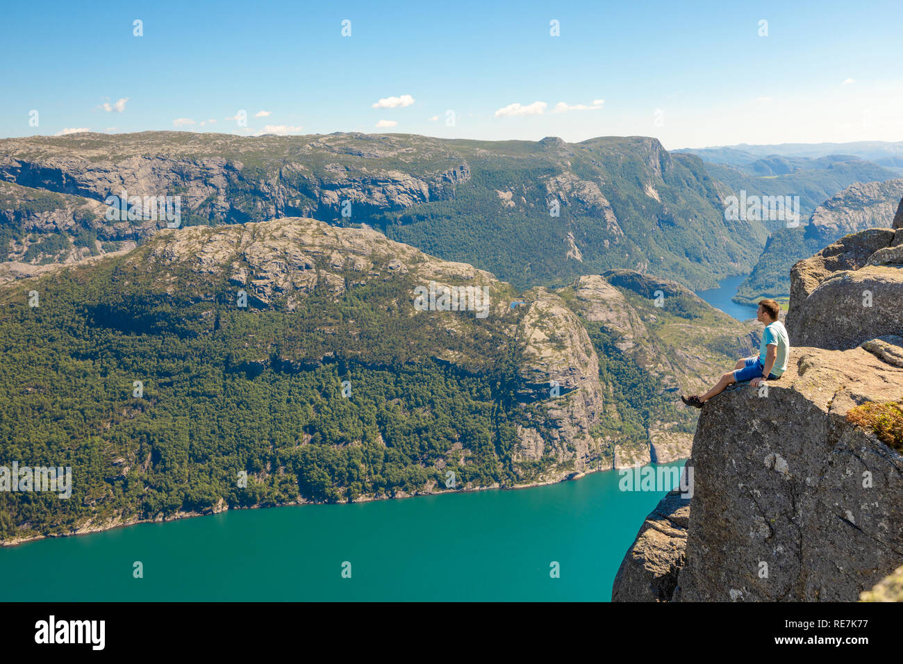 Hiker standing on Preikestolen and looking on the fjerd, Preikestolen ...
