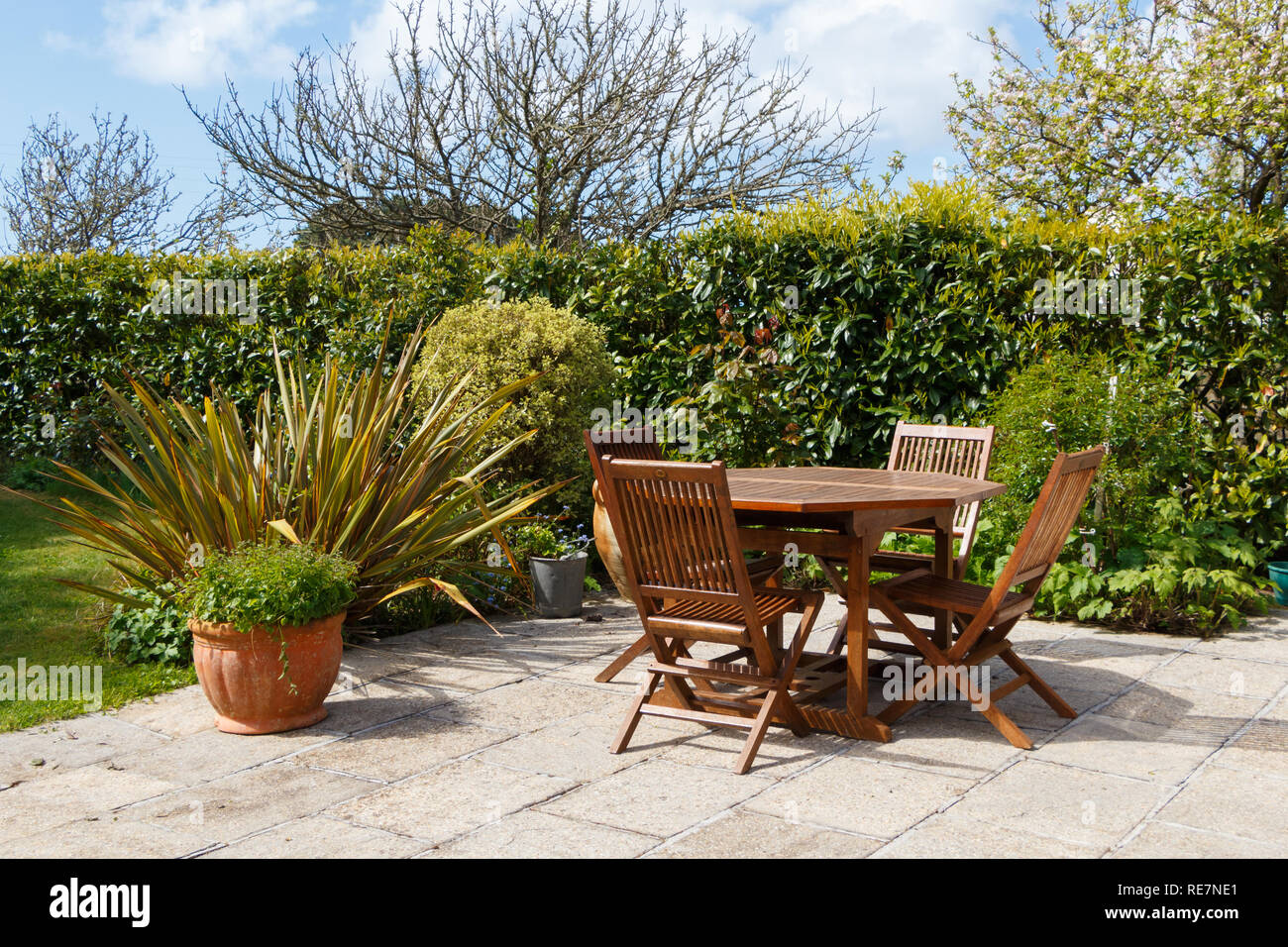 Terrace in pavement and wooden garden furniture in a garden Stock Photo ...