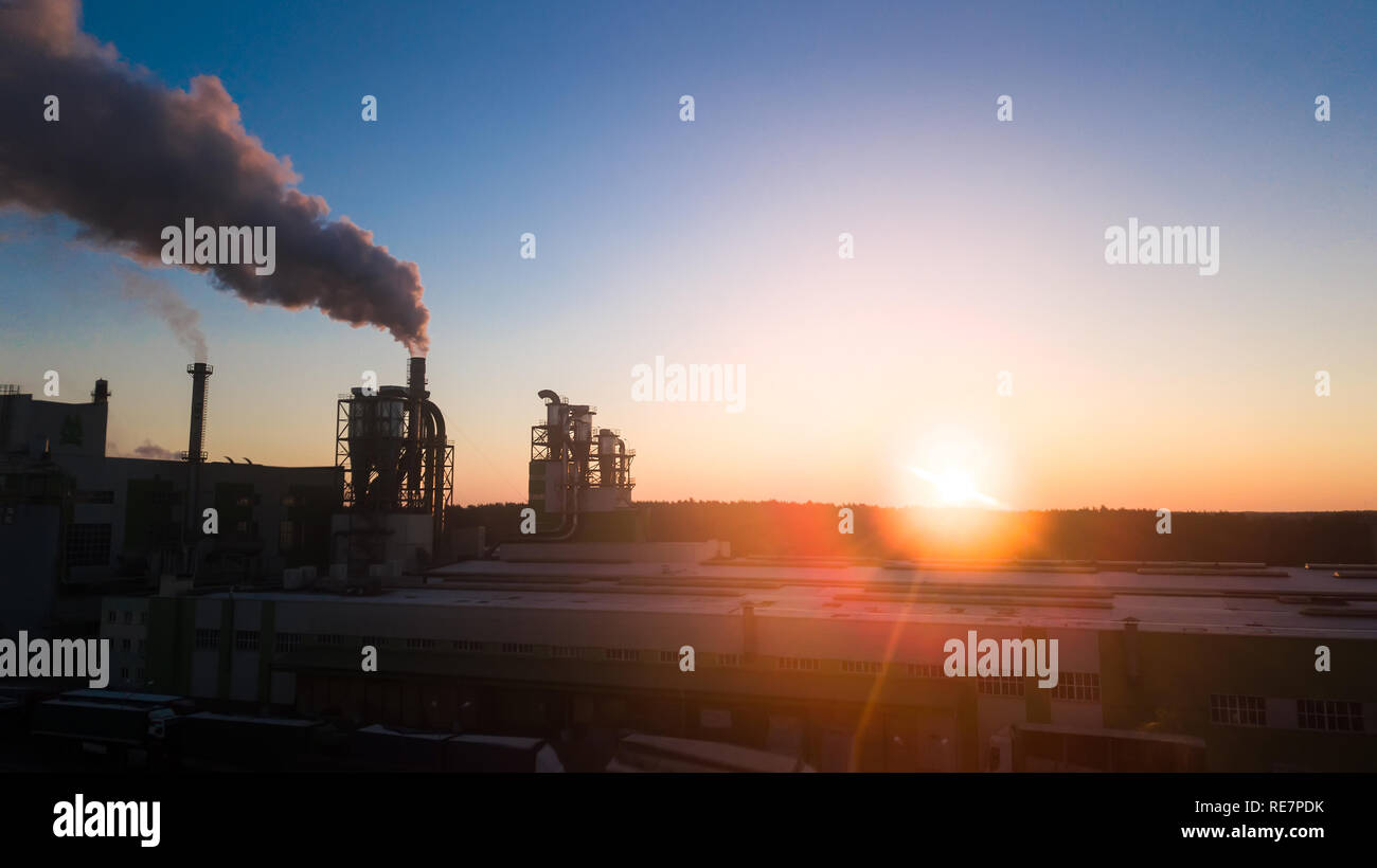 Sunrise over the factory. The smoke comes from the pipes at dawn Stock ...