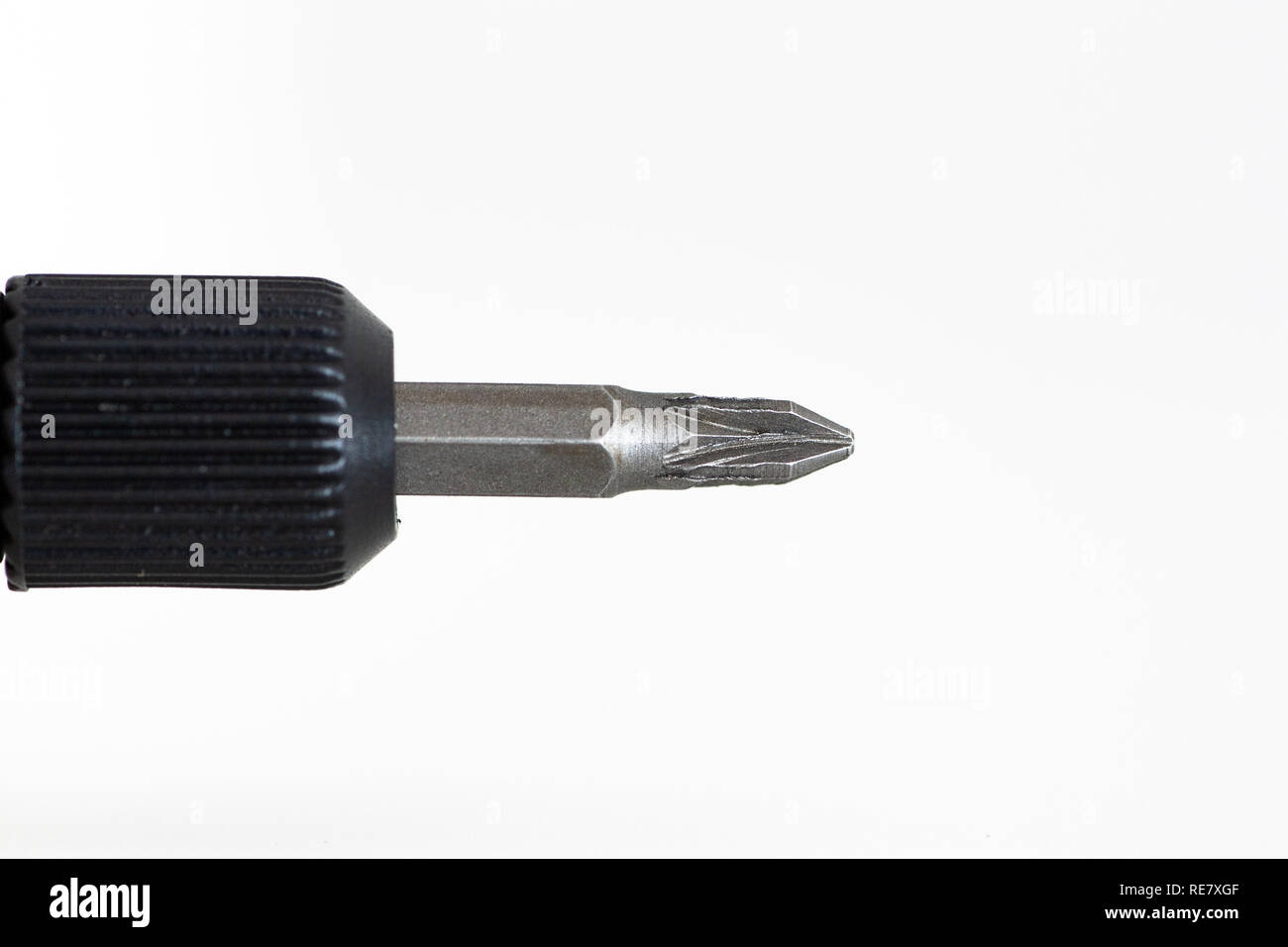 Small screwdriver head close up macro black handle isolated against ...