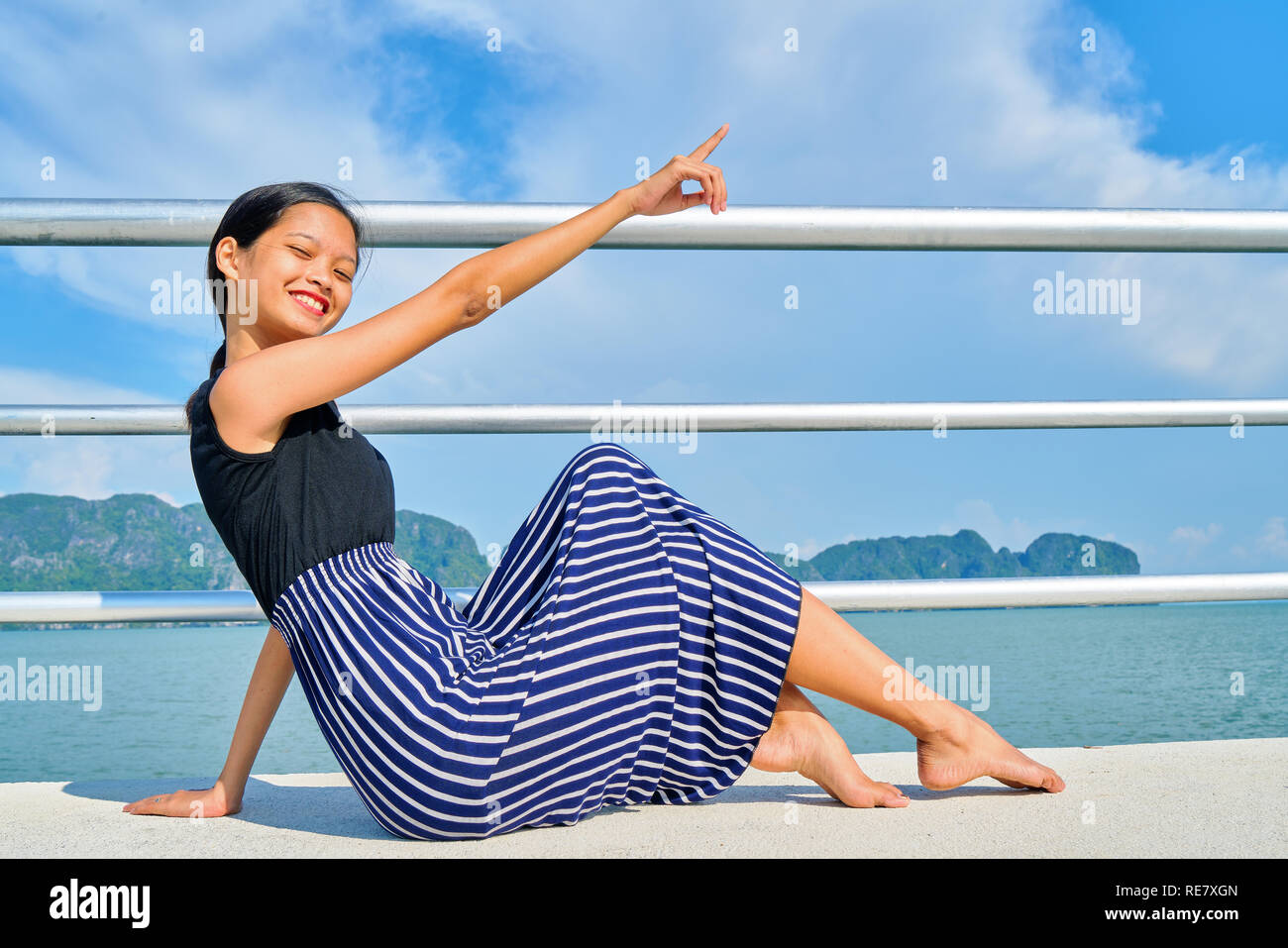Teenager sitting pointing full length hi-res stock photography and ...