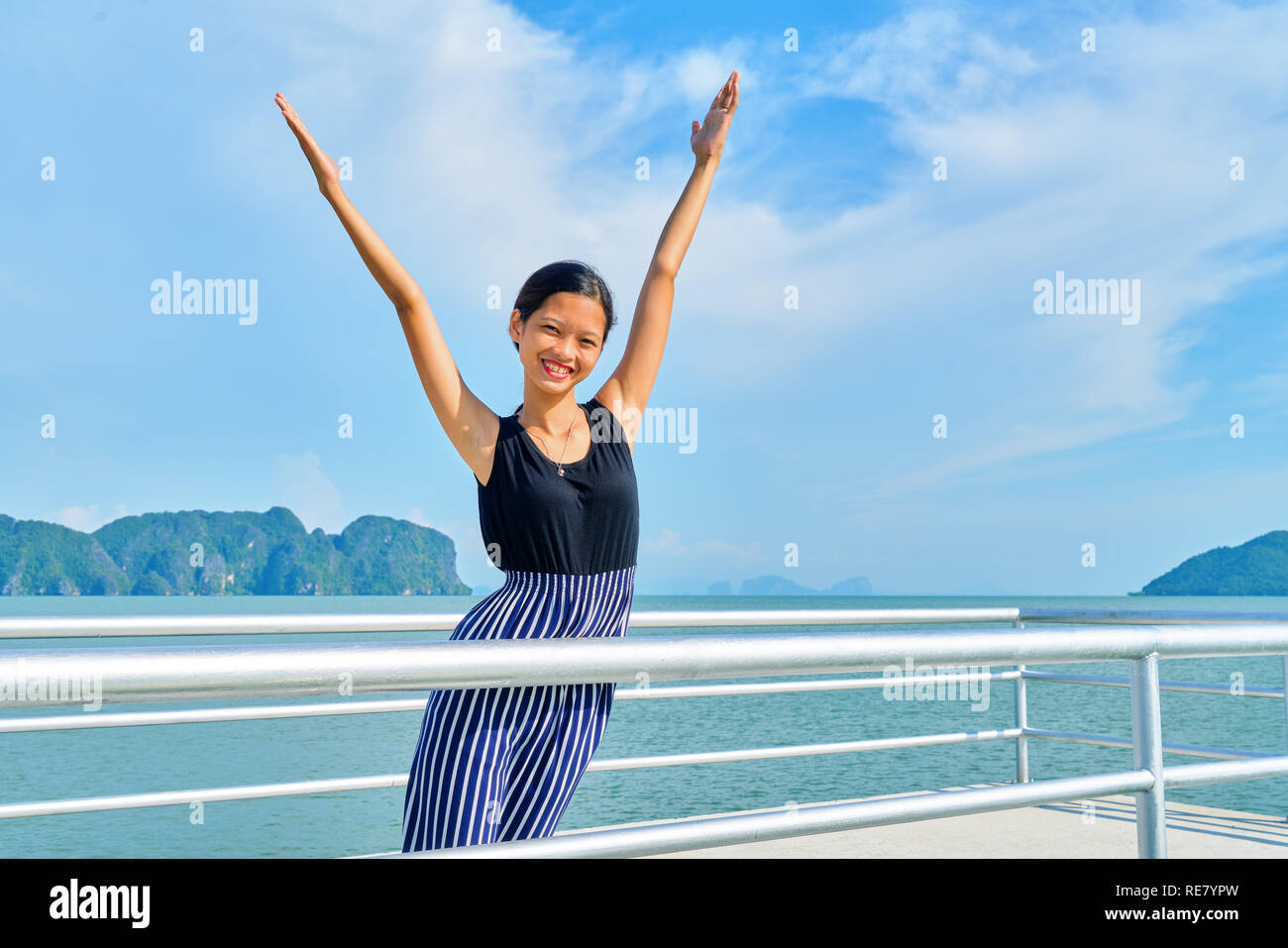 Beautiful woman posing - arms raised and enjoying Stock Photo - Alamy