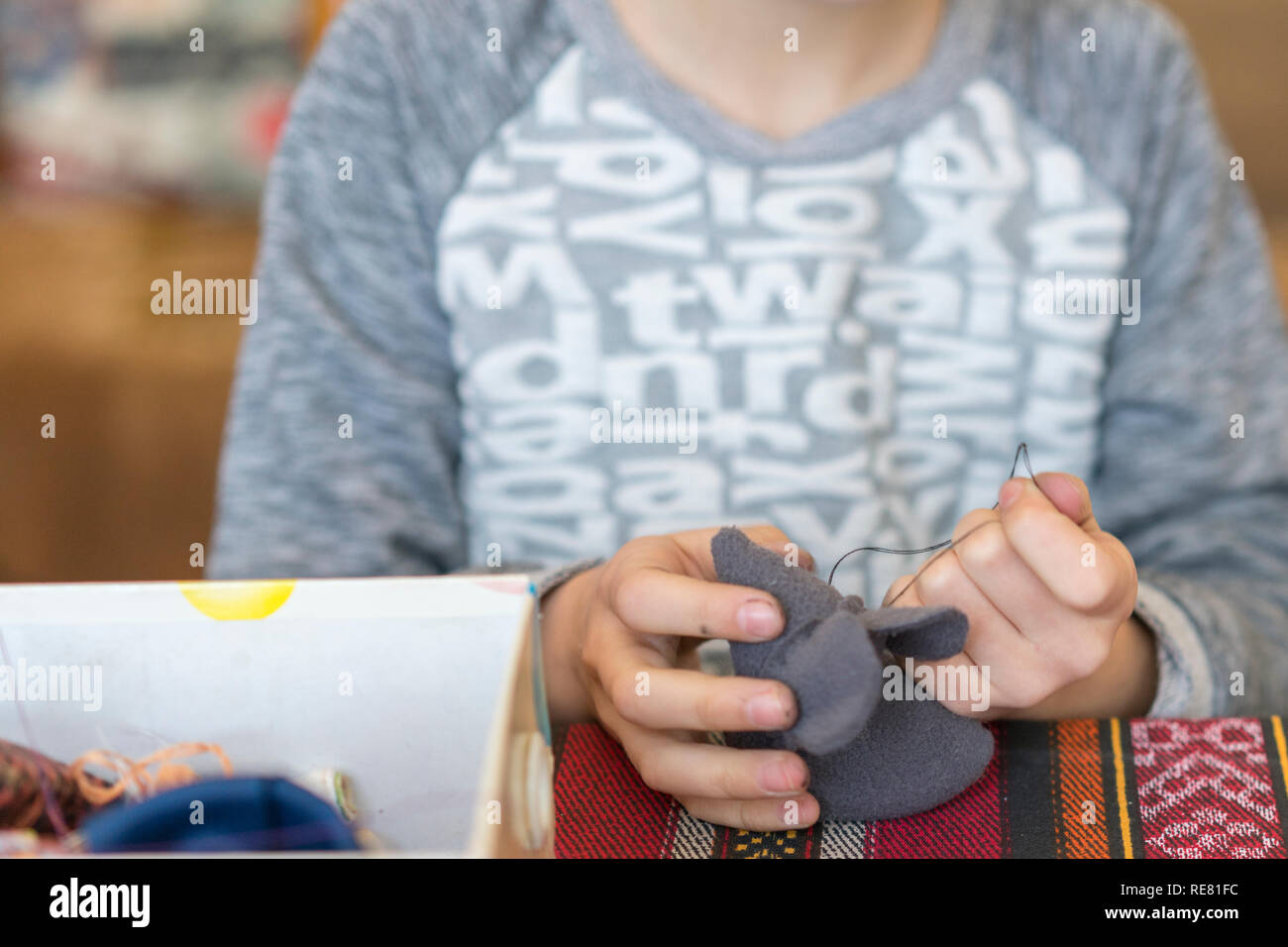 Handicraft courses. The girl is learning to sew. a girl with threads ...