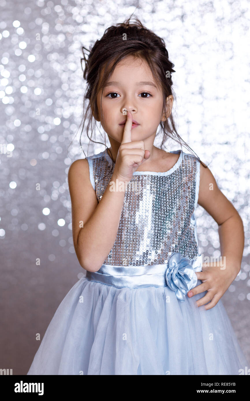cute smiling little child girl in silver and blue dress Stock Photo - Alamy