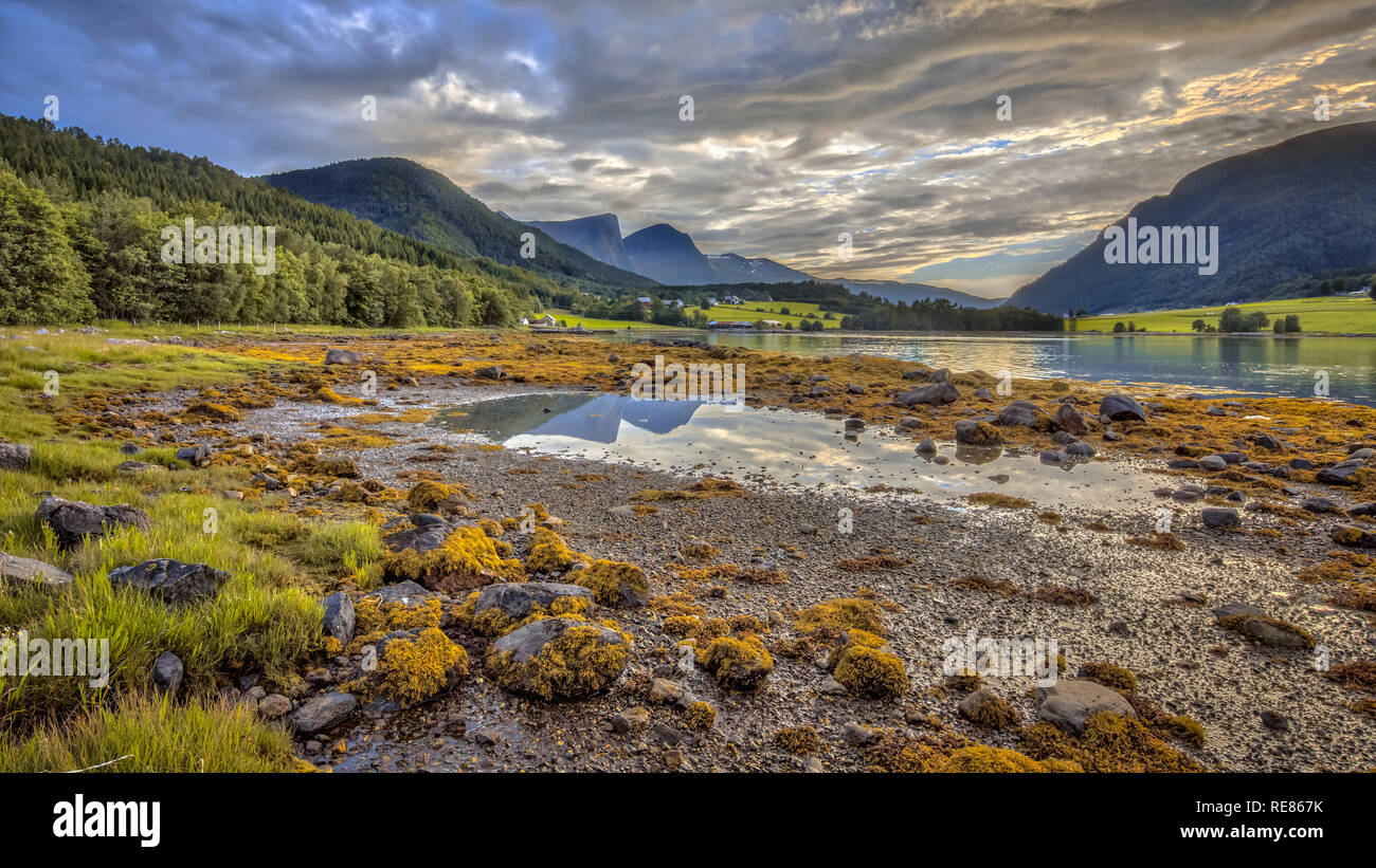 Fjord landscape with mountains rocks and stones at low tide on ...