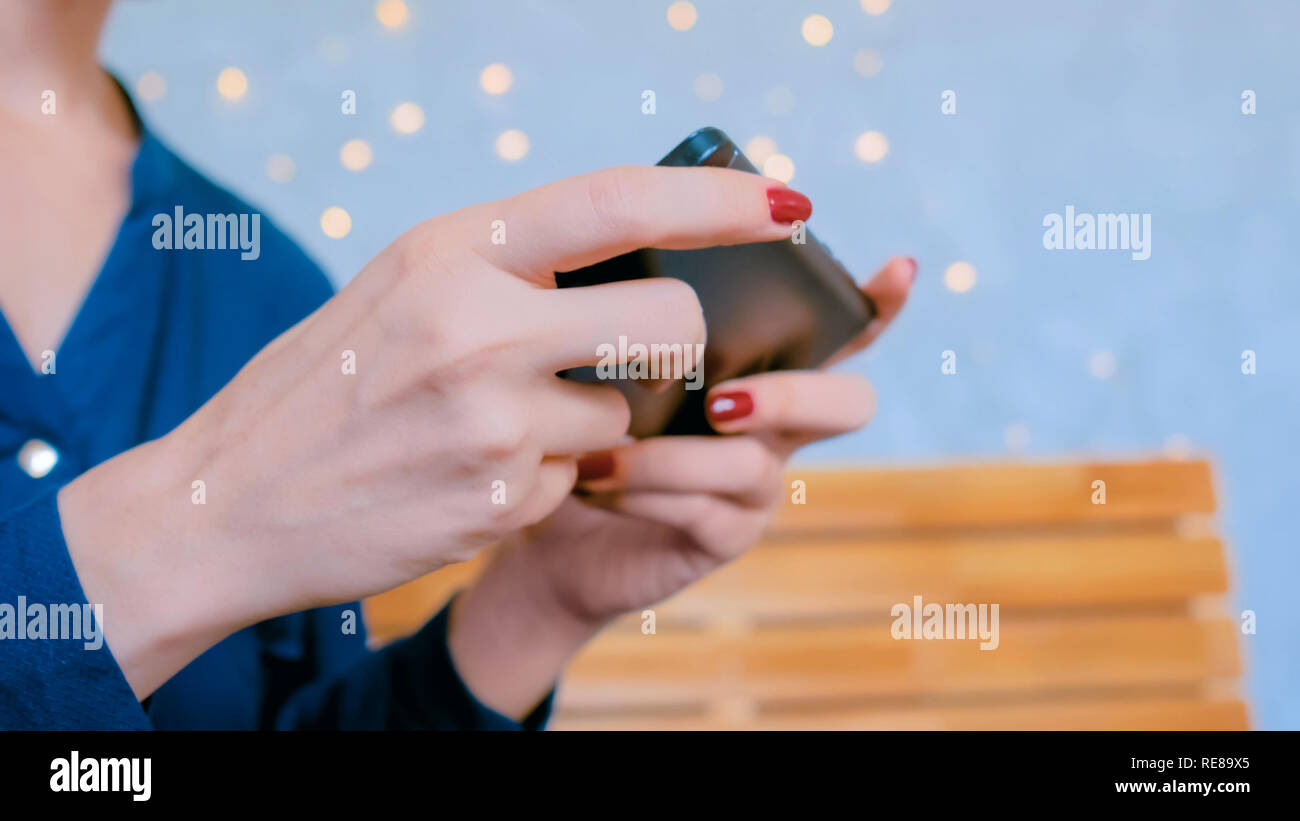 Woman gamer playing mobile game with smartphone. Gaming, hobby ...