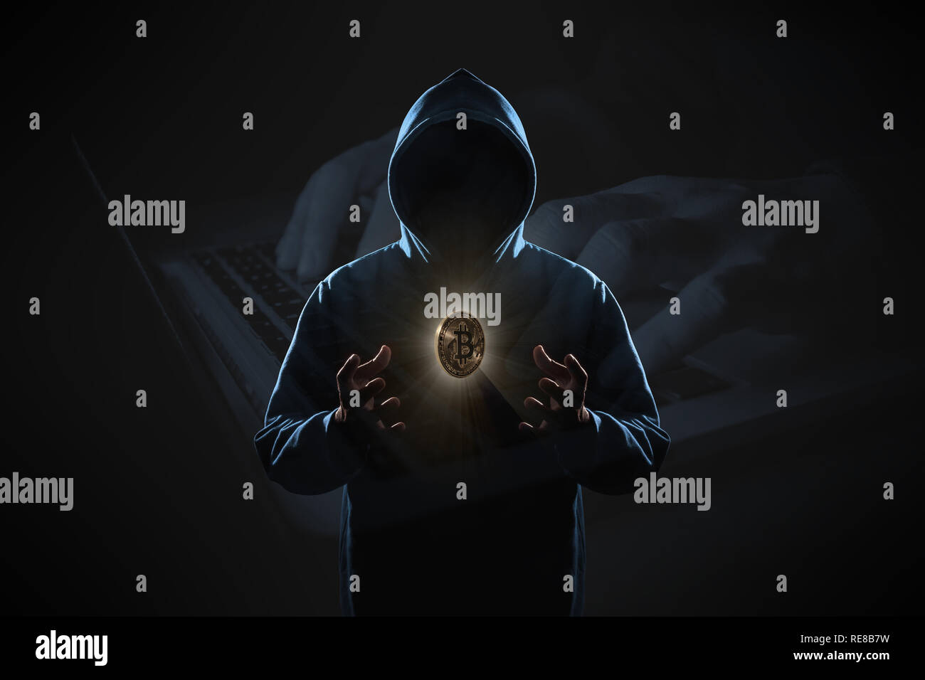 Golden Bitcoin floating above of hacker's hand in dark on hacker ...