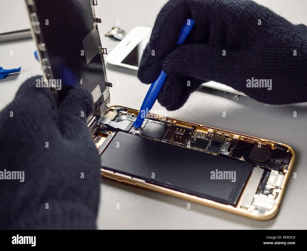 Technician or engineer disassembling components broken smartphone for ...