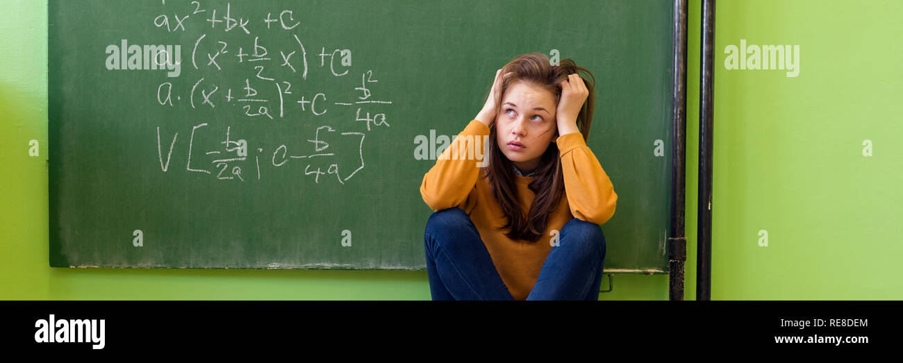 Teenager girl in math class overwhelmed by the math formula. Pressure ...
