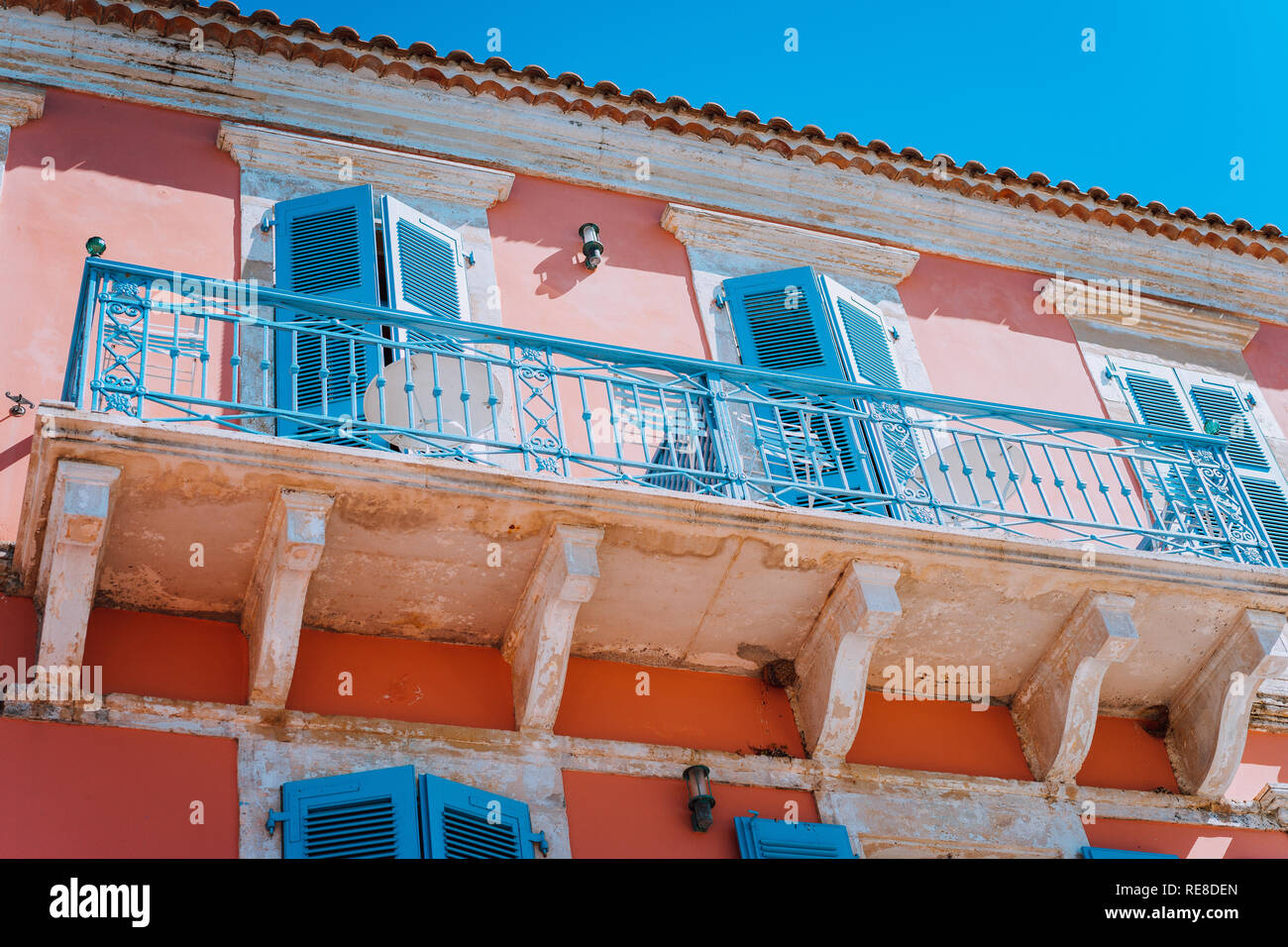 Traditional greek house facade with blue windows, shutters and ...