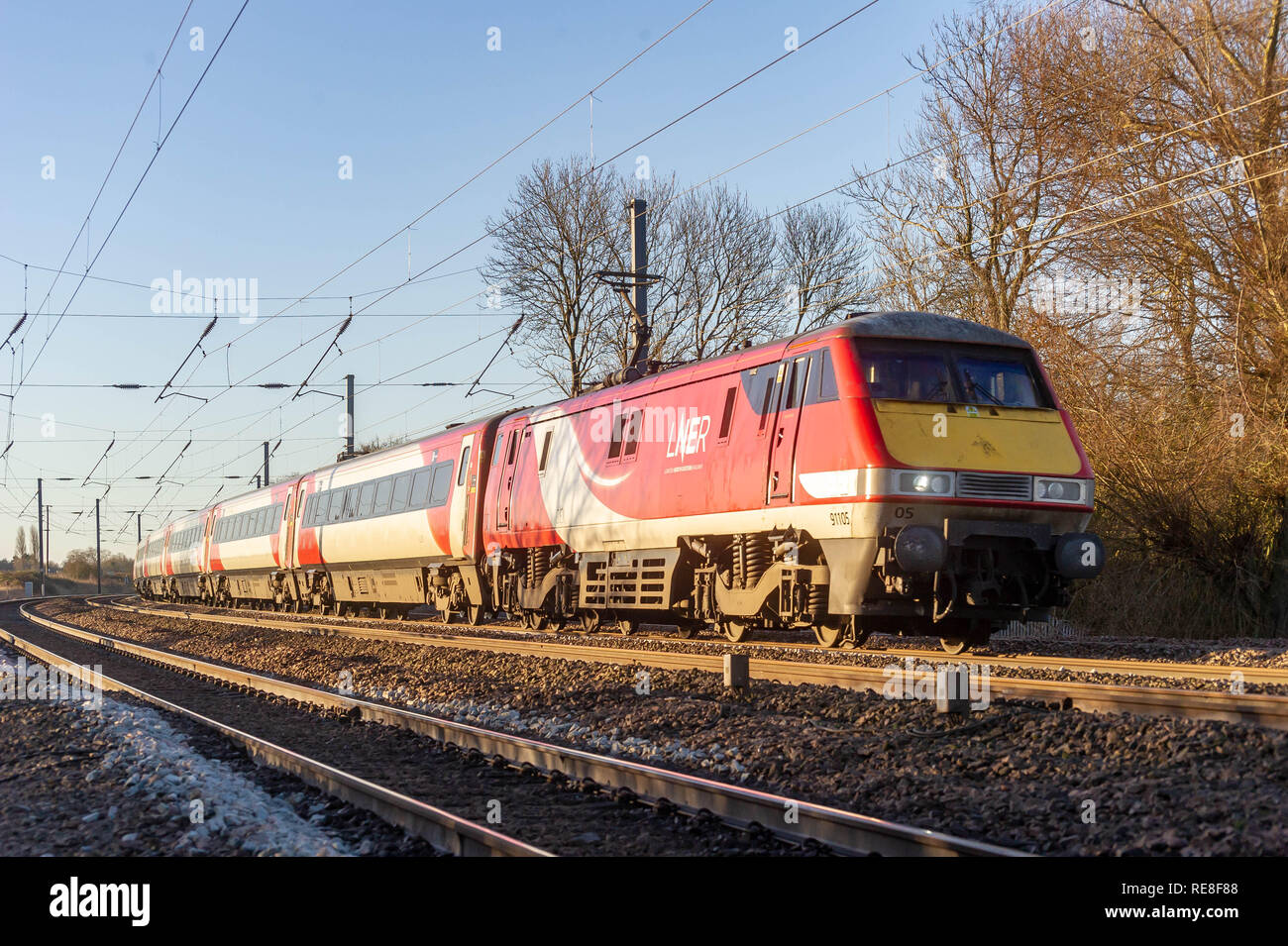 Class 91 105 races north at Great Paxton, Cambridgeshire with a LNER ...