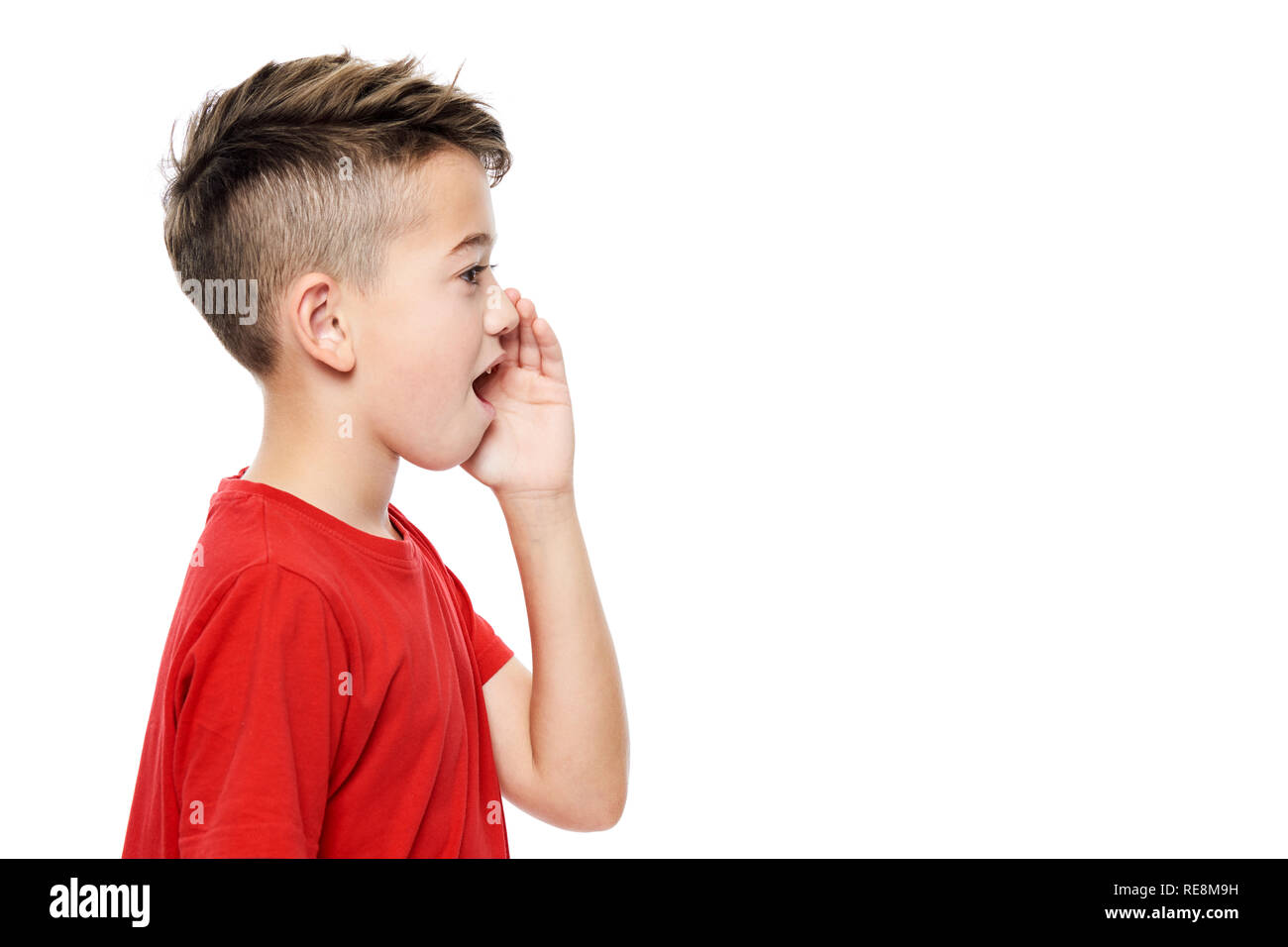 Cute boy in red T-shirt shouting. Speech therapy concept over white ...
