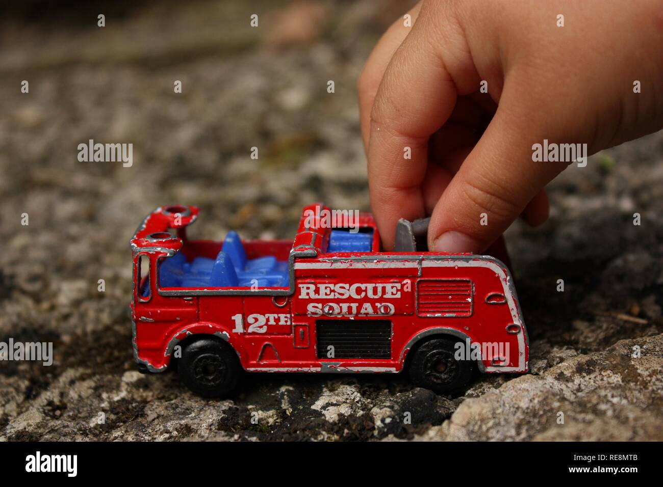 Child playing with toy fire engine truck Stock Photo - Alamy