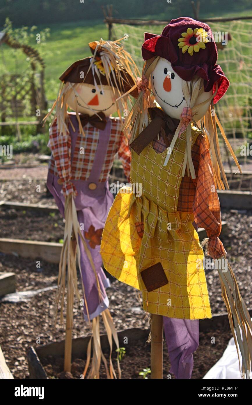 Girl and boy scarecrows in a garden Stock Photo - Alamy