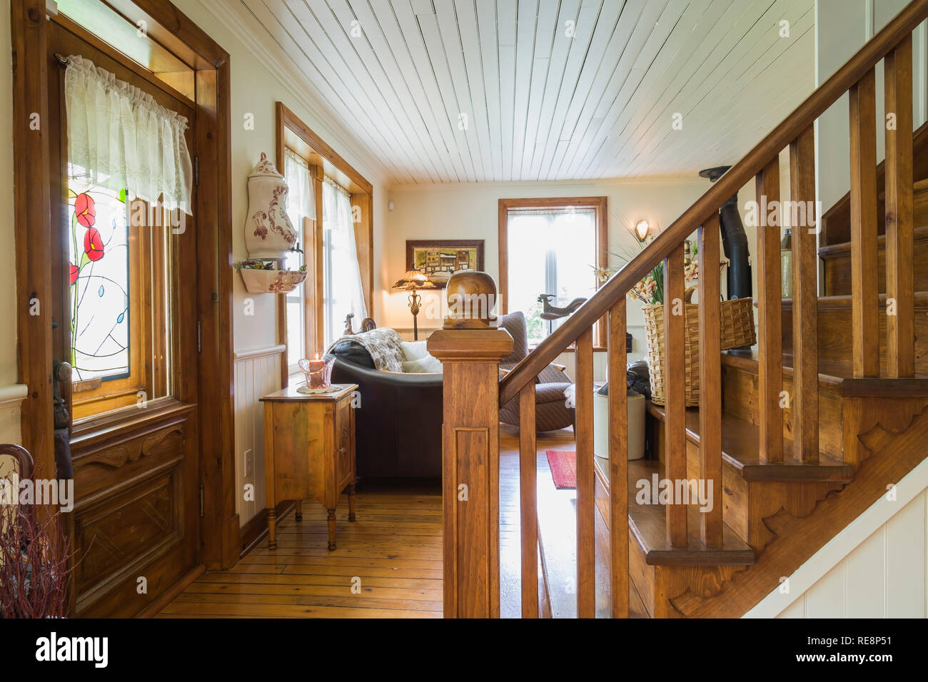 Brown stained pinewood stairs between the dining room and living room ...