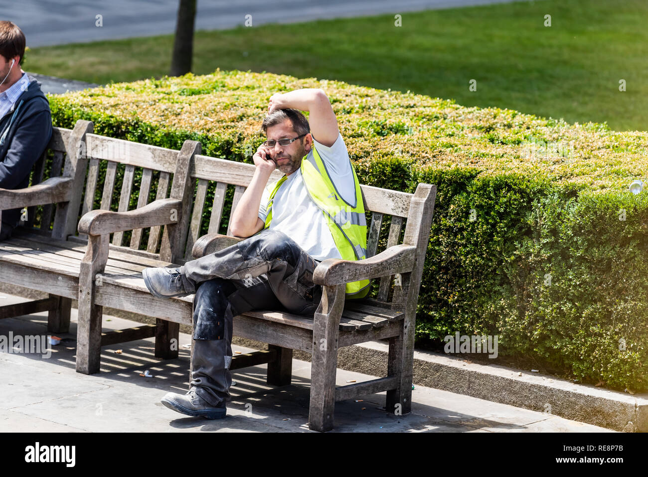 Person sitting on street bench city hi-res stock photography and images ...