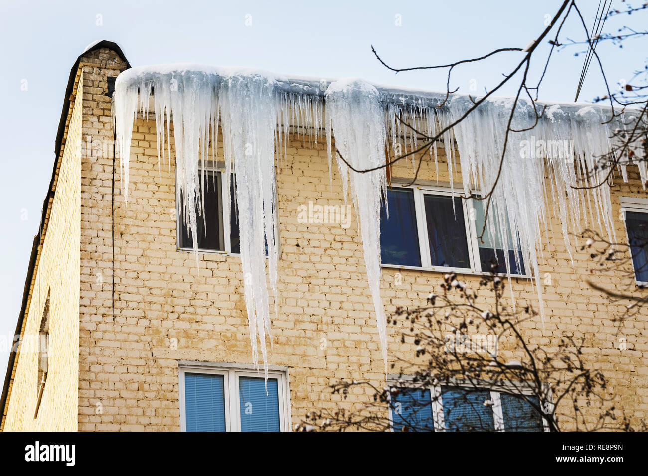 Dangerous icicles on the eaves of houses. Ice blocking windows and ...