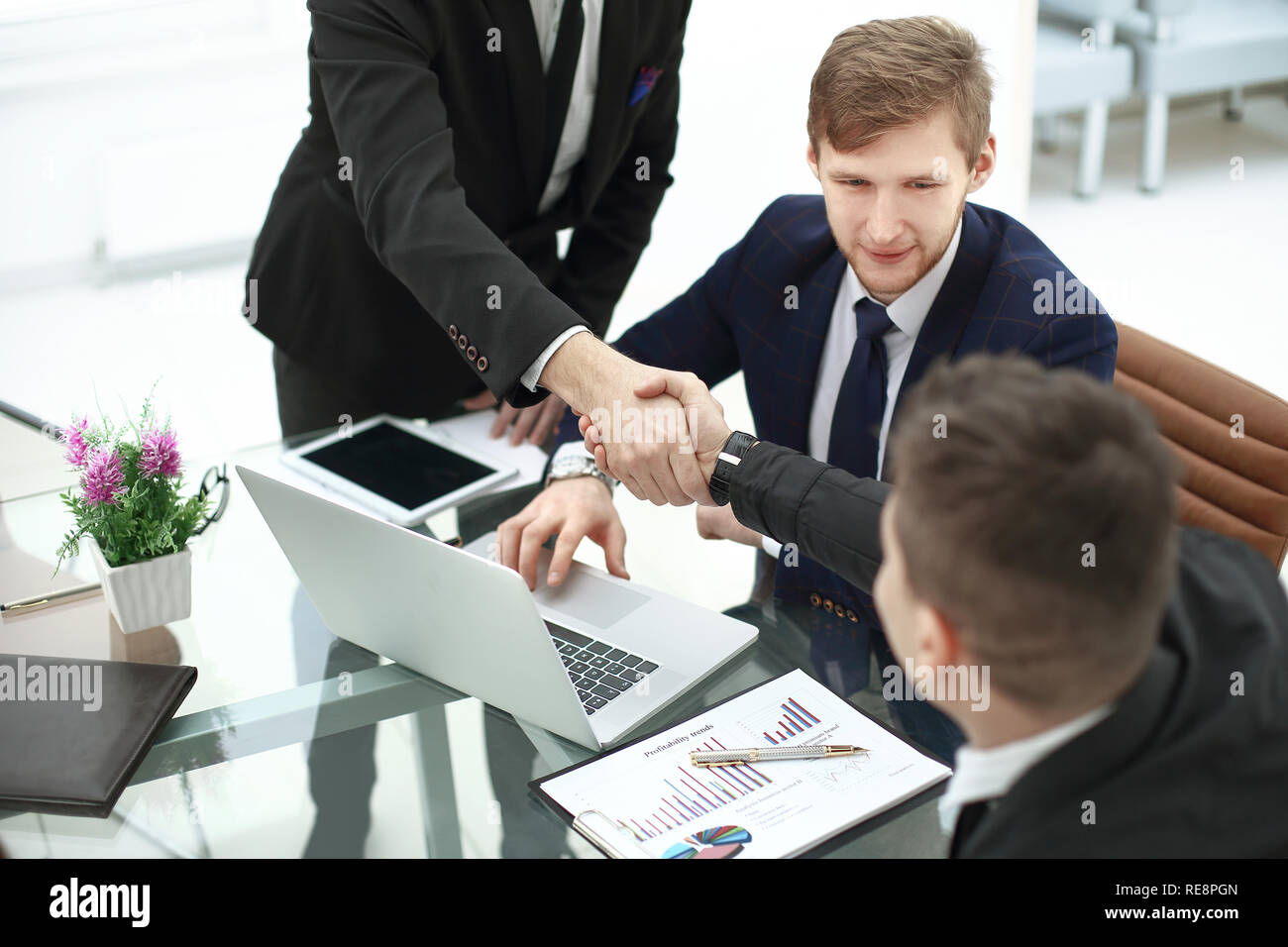 Manager's and client's handshakes over the Desk in the Bank's office ...
