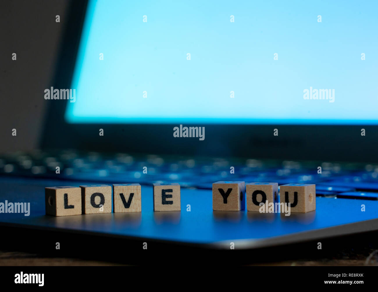 Conceptual image of text Love you in wood blocks on computer with mood ...