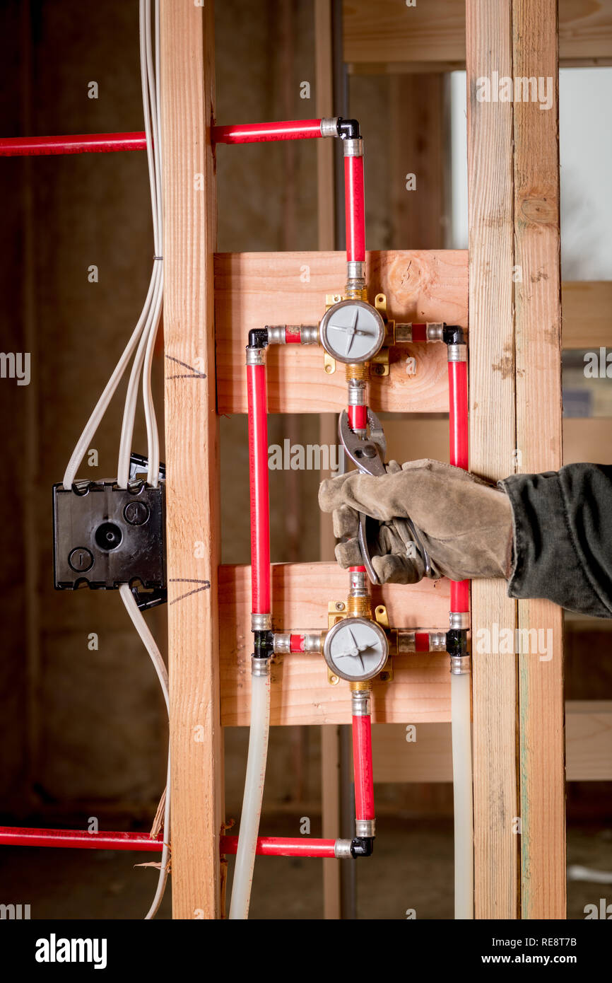 New home construction man works on plumbing Stock Photo - Alamy