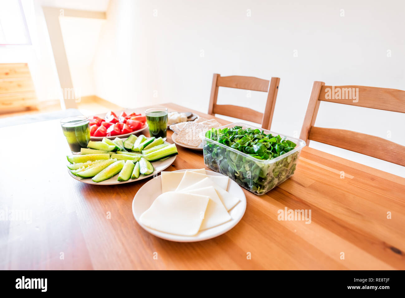 Wooden table setting of healthy vegan vegetarian lunch green vegetables ...