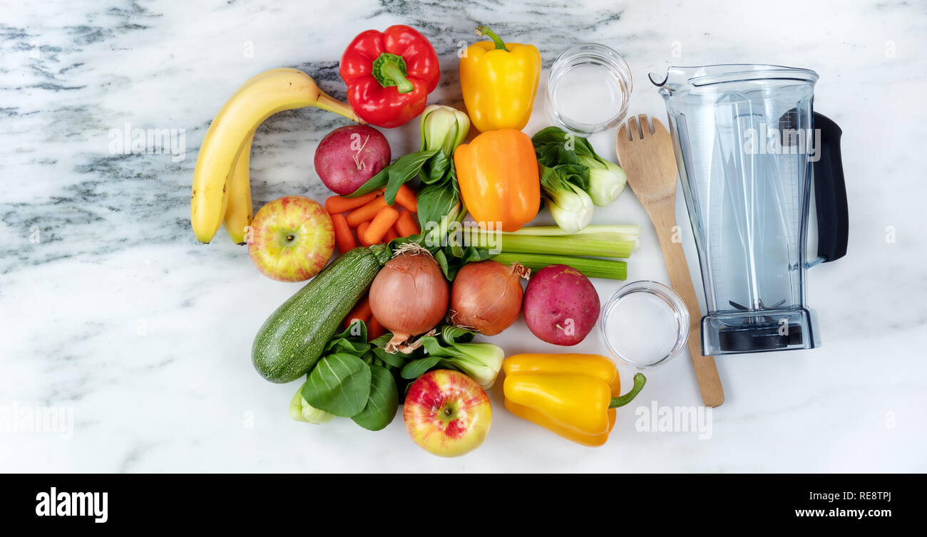Raw organic vegetables and fruits with blender on marble stone ...