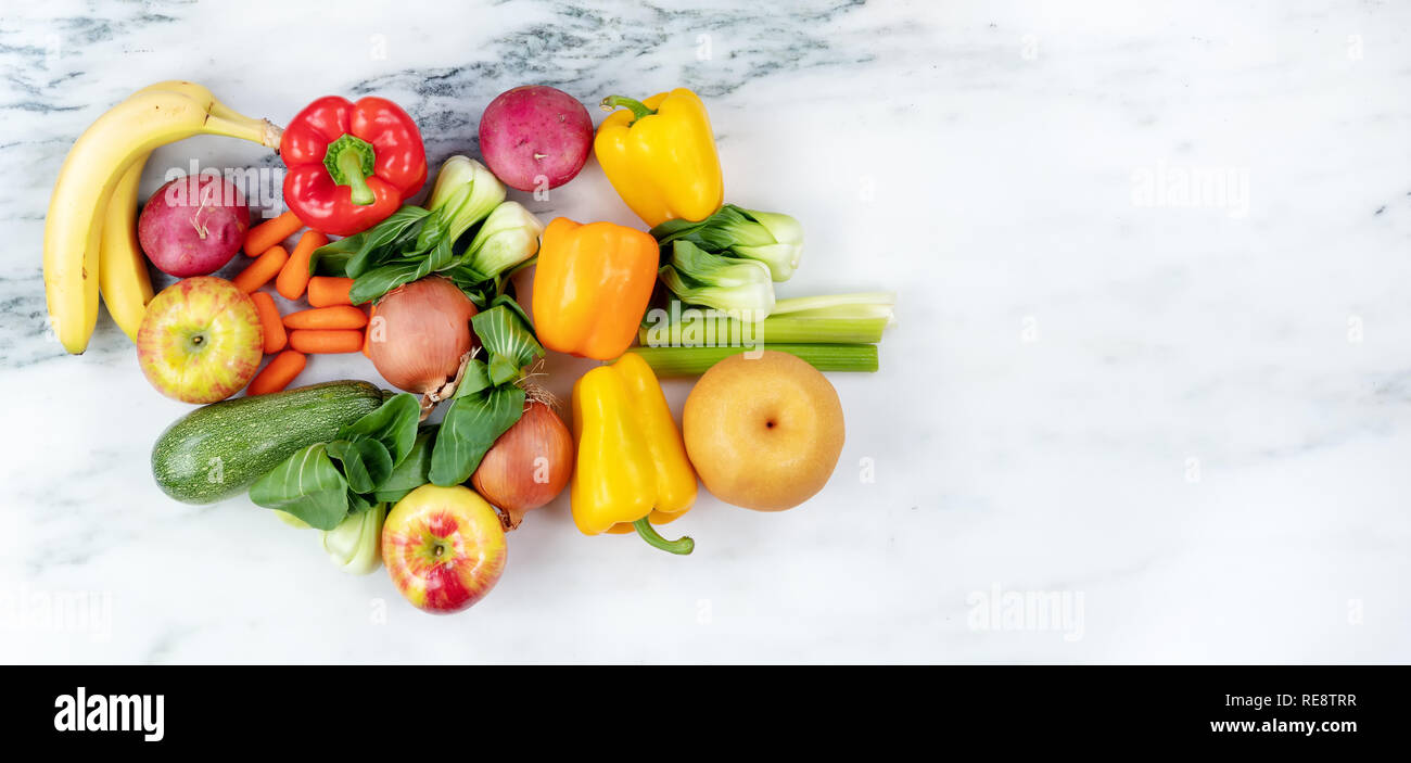 Raw organic vegetables and fruits on marble stone background for ...