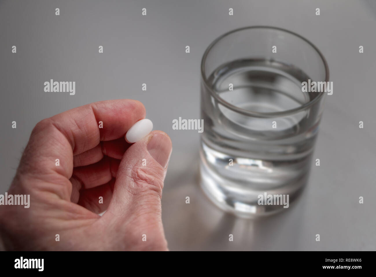 adult male senior taking medication with water Stock Photo - Alamy