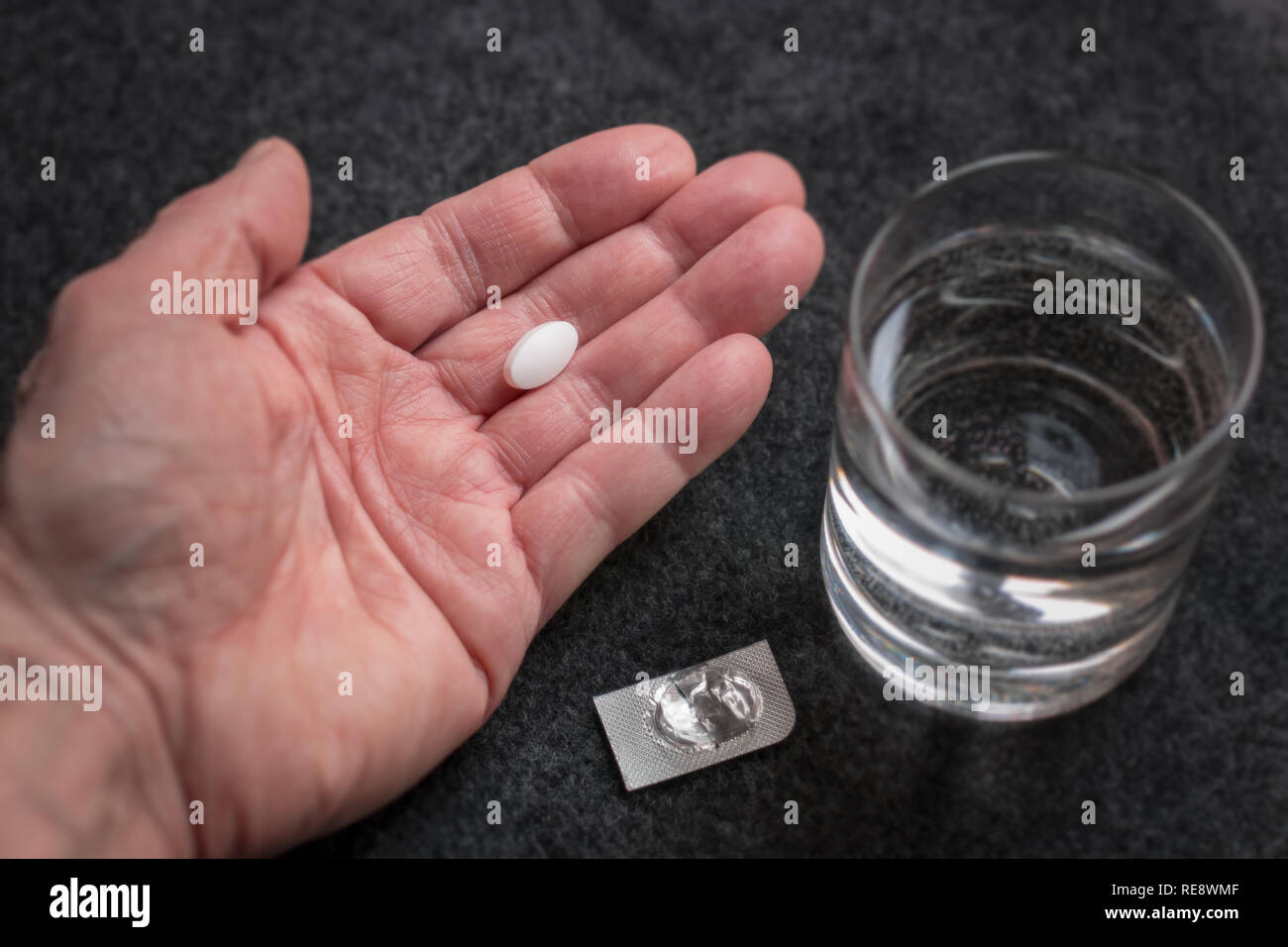 adult male senior taking medication with water Stock Photo - Alamy
