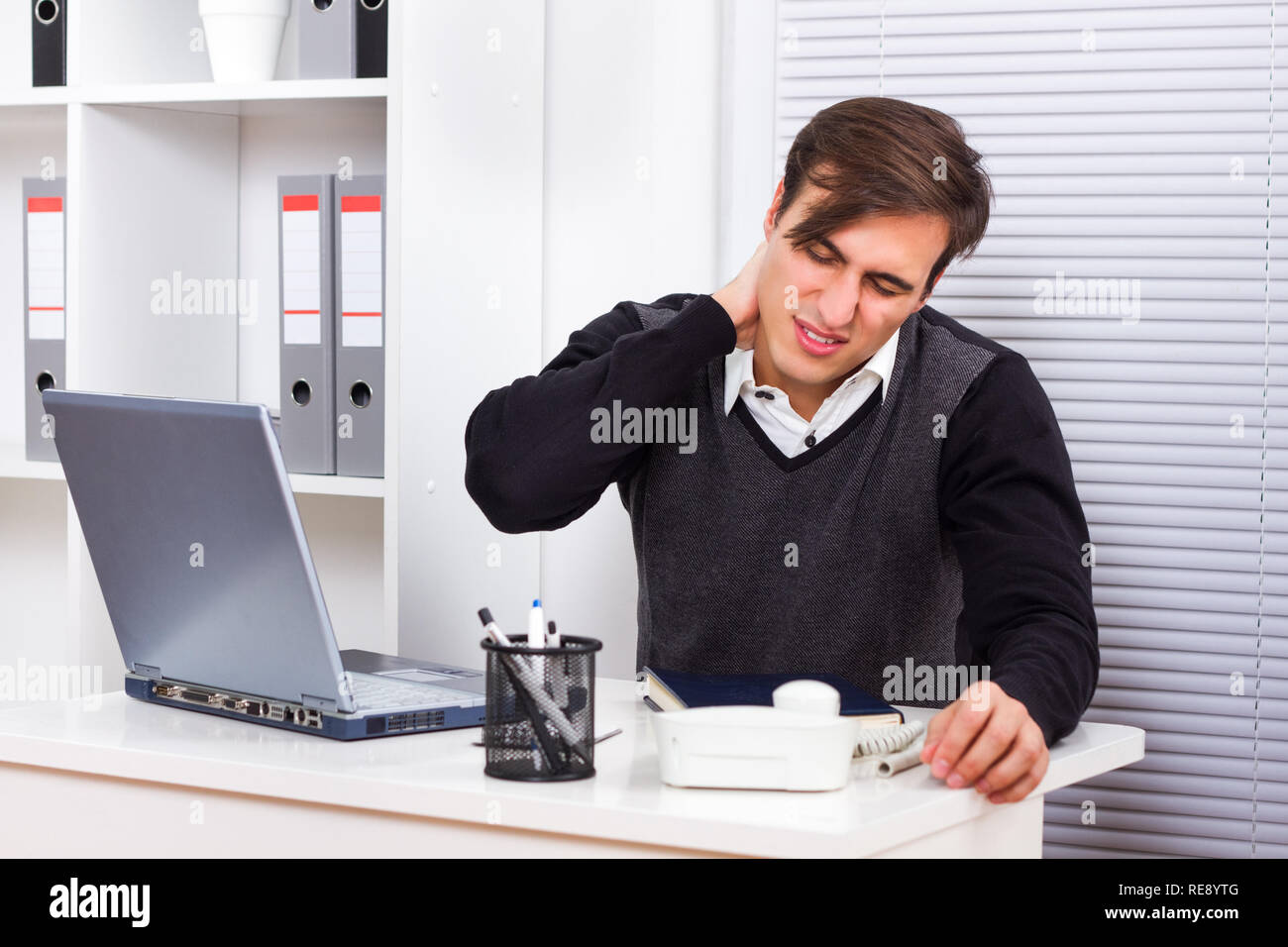 An office worker experiencing a neck pain Stock Photo - Alamy