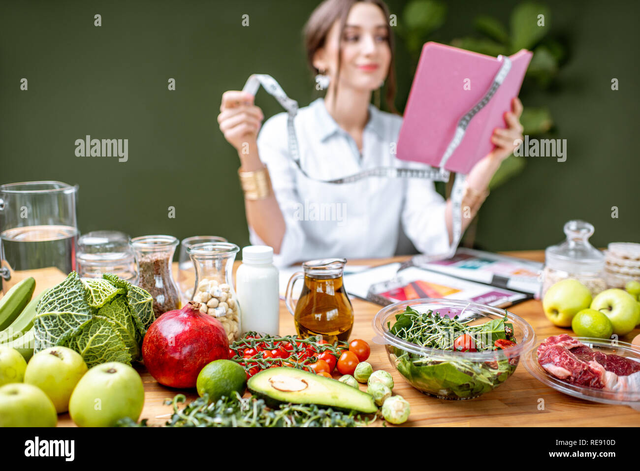 Woman dietitian in medical uniform working on a diet plan sitting with ...