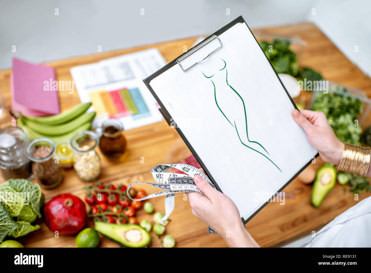 Holding a drawing with slim woman's figure with healthy food on the ...