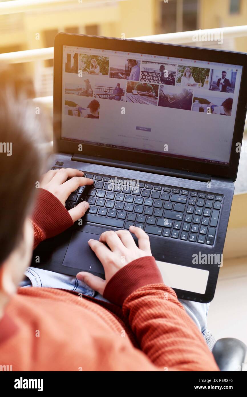 Picture of boy hand using laptop Stock Photo - Alamy