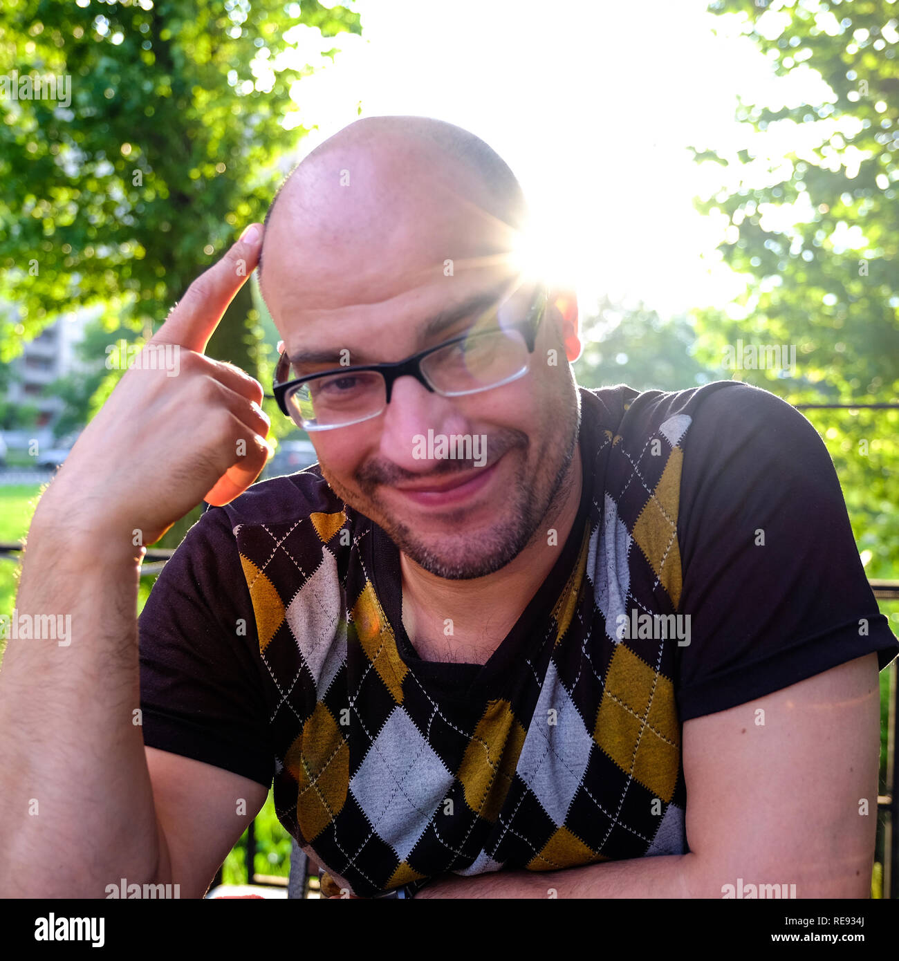 The man drinking cider jokes, smiles. A young man drinks cider in an ...
