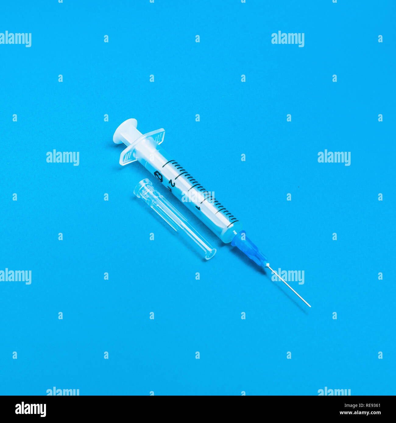 Insulin syringe closeup on blue background. The concept of fighting ...