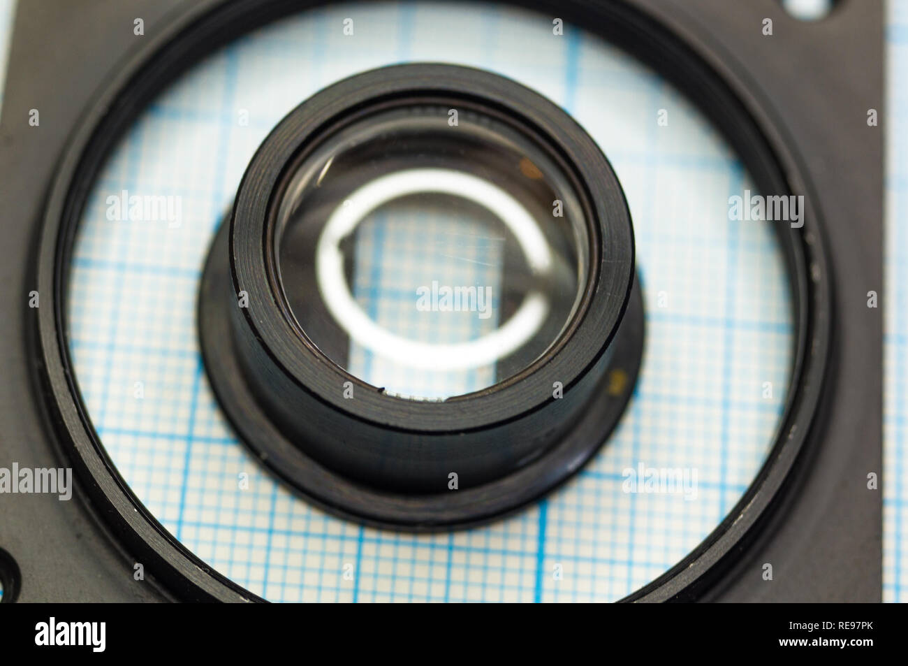 parts are completely disassembled old retro film SLR camera on graph ...