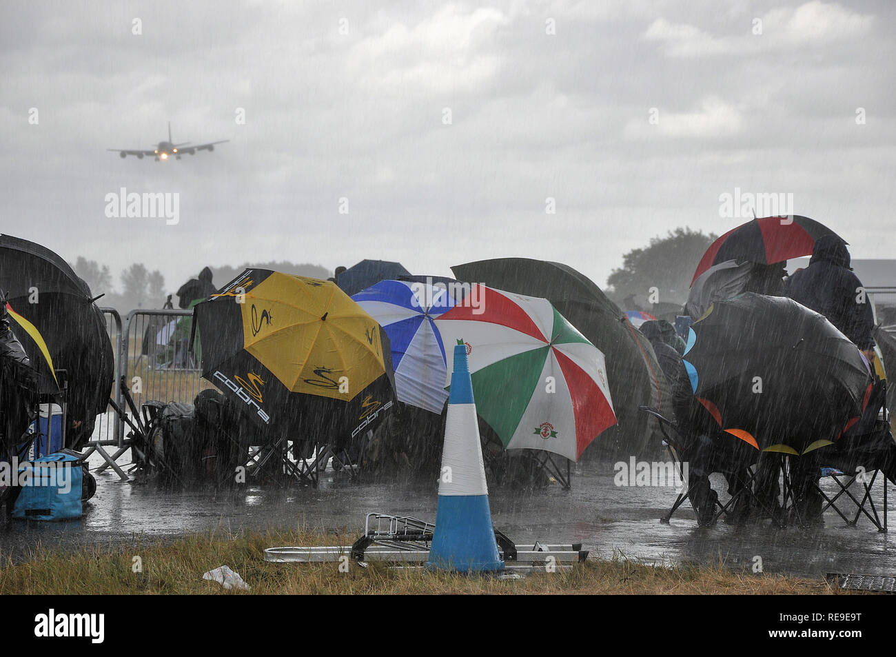 Plane spotters at an airshow suffering heavy rain bad weather. Extreme ...