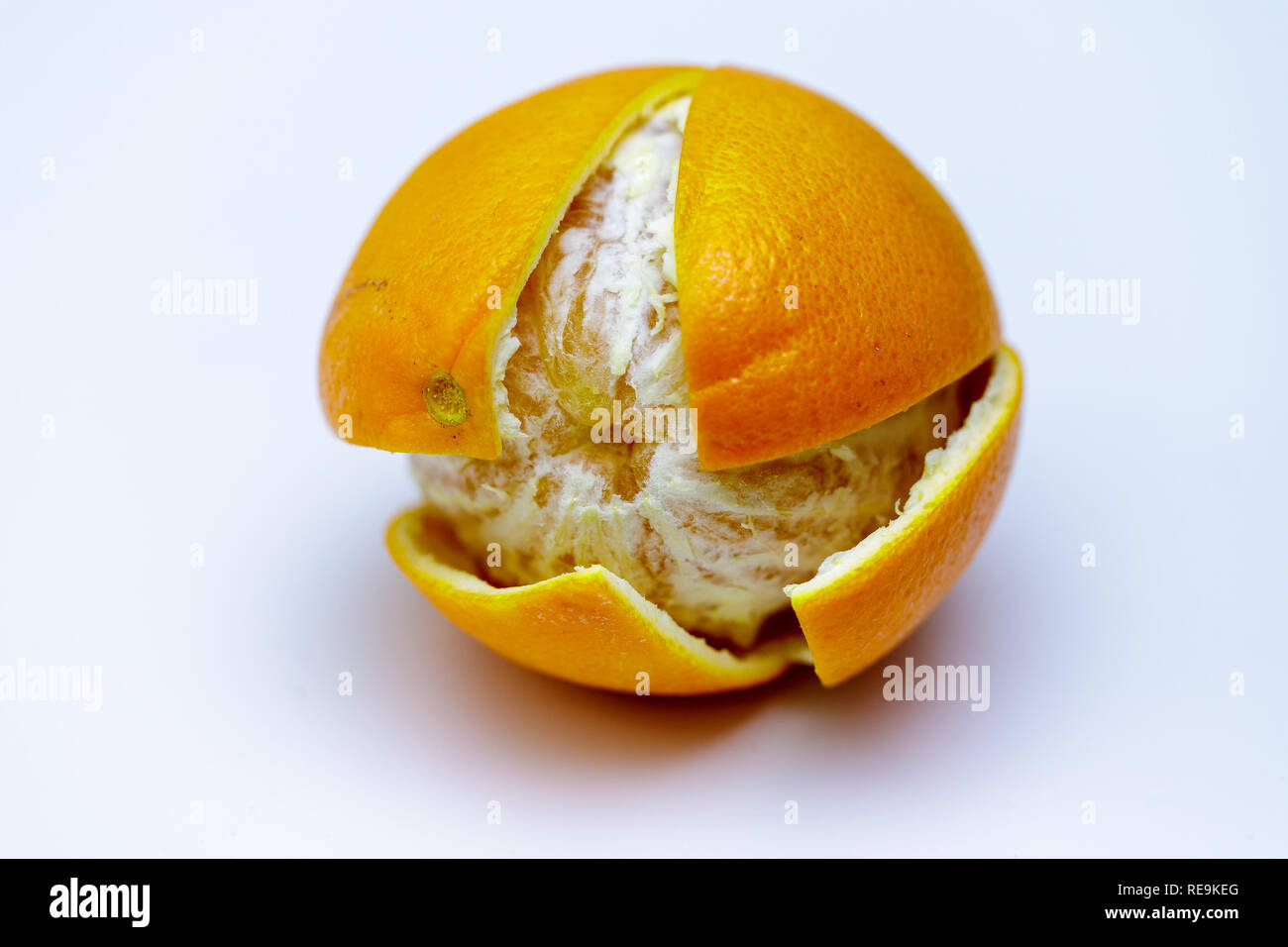 Whole orange on white background with cut peel close up Stock Photo - Alamy