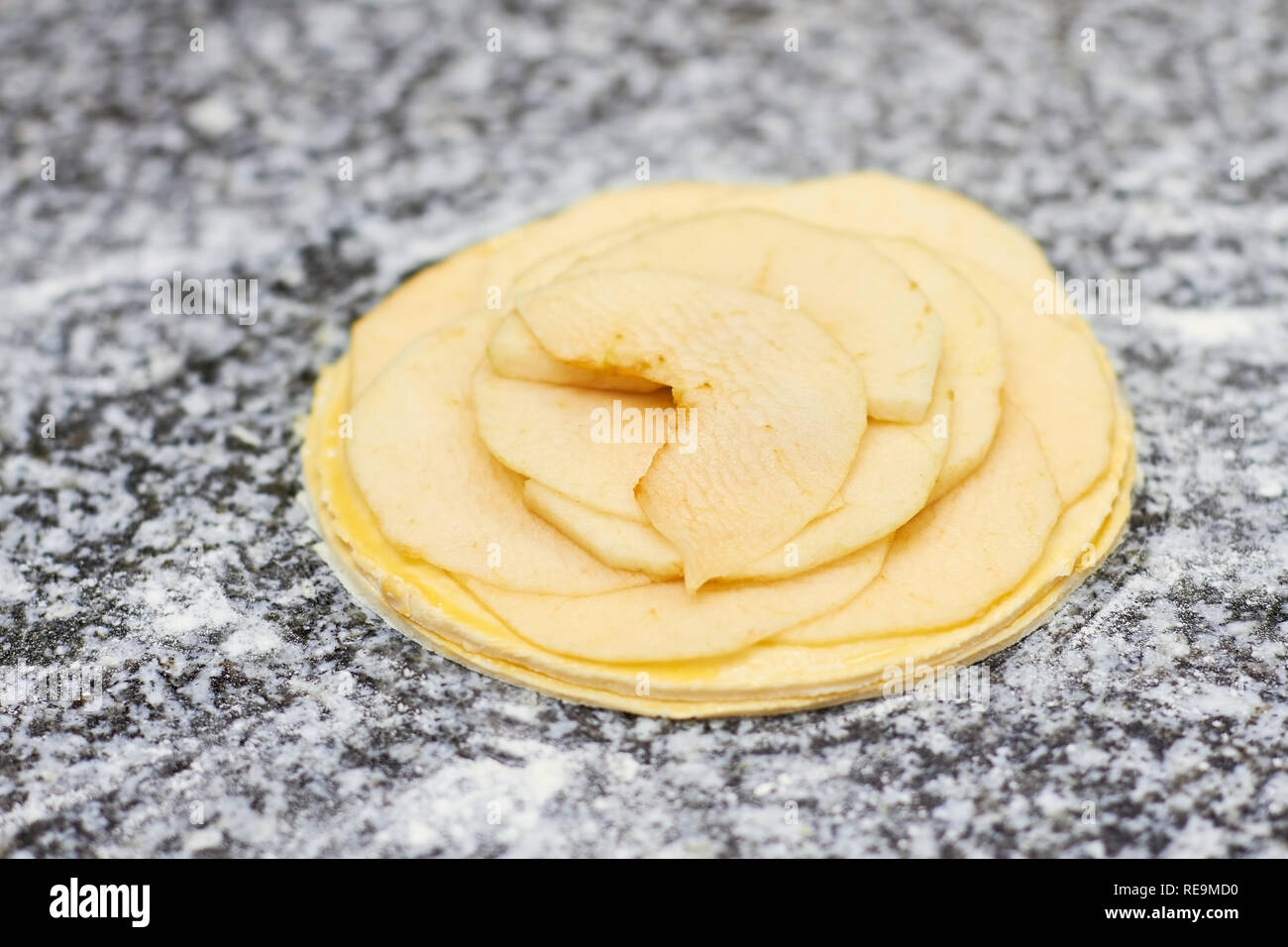 Many layers of apple slices on dough basis. Uncooked apple tart layers ...