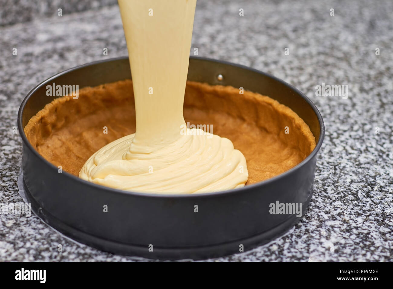 Batter flowing into pie crust. Pouring filling into pie crust Stock ...