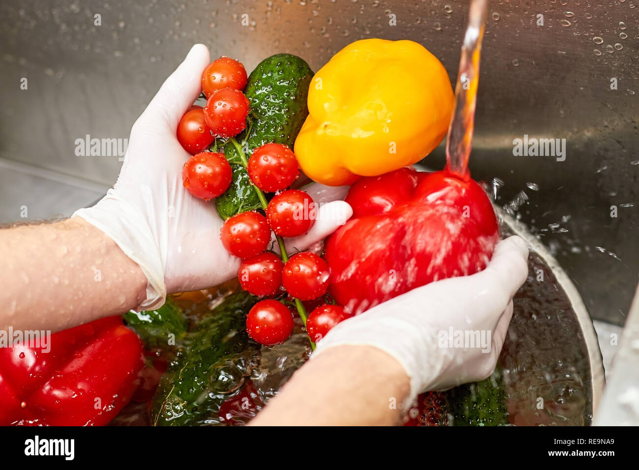 Close up washing vegetables under running tap water. Fresh vegetables ...