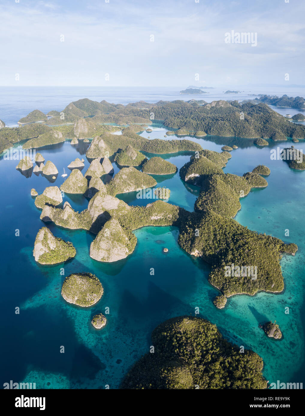 Remote limestone islands form a maze in a tropical lagoon in Raja Ampat ...