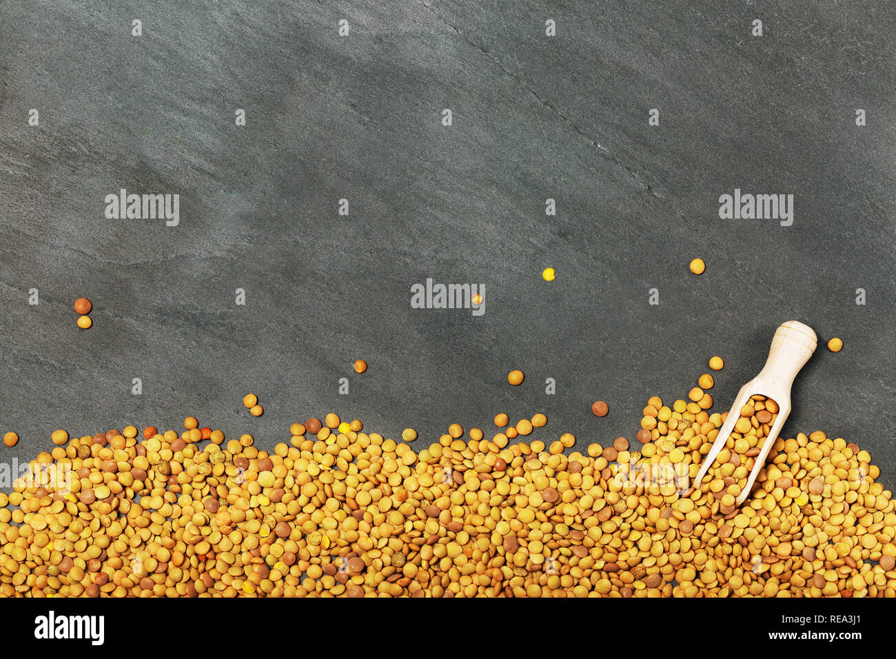 Raw lentils on balck stone background. Healthy vegetarian food concept ...